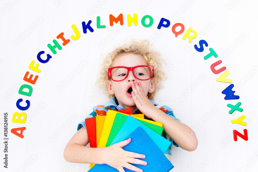 Child learning letters of alphabet and reading Stock Photo | Adobe Stock