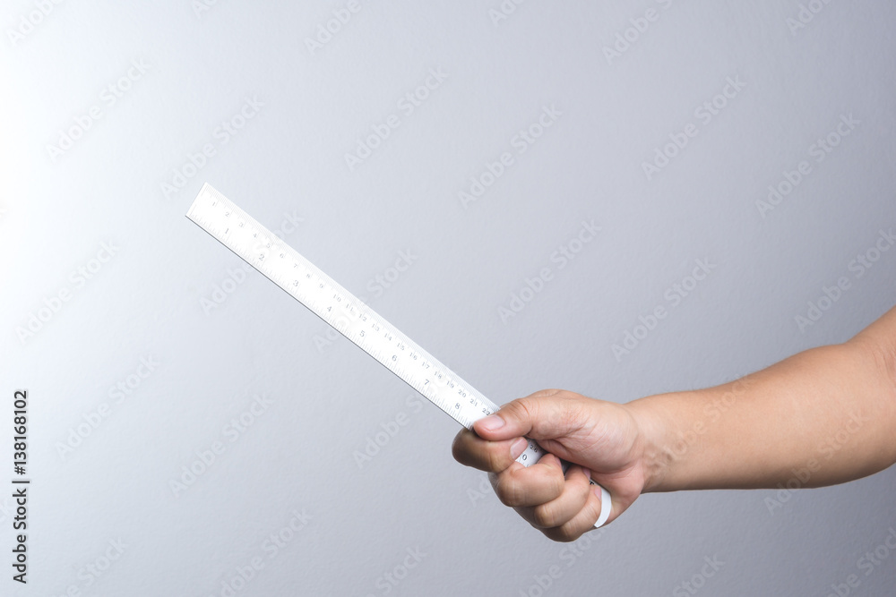 Hand holding a ruler Stock Photo | Adobe Stock