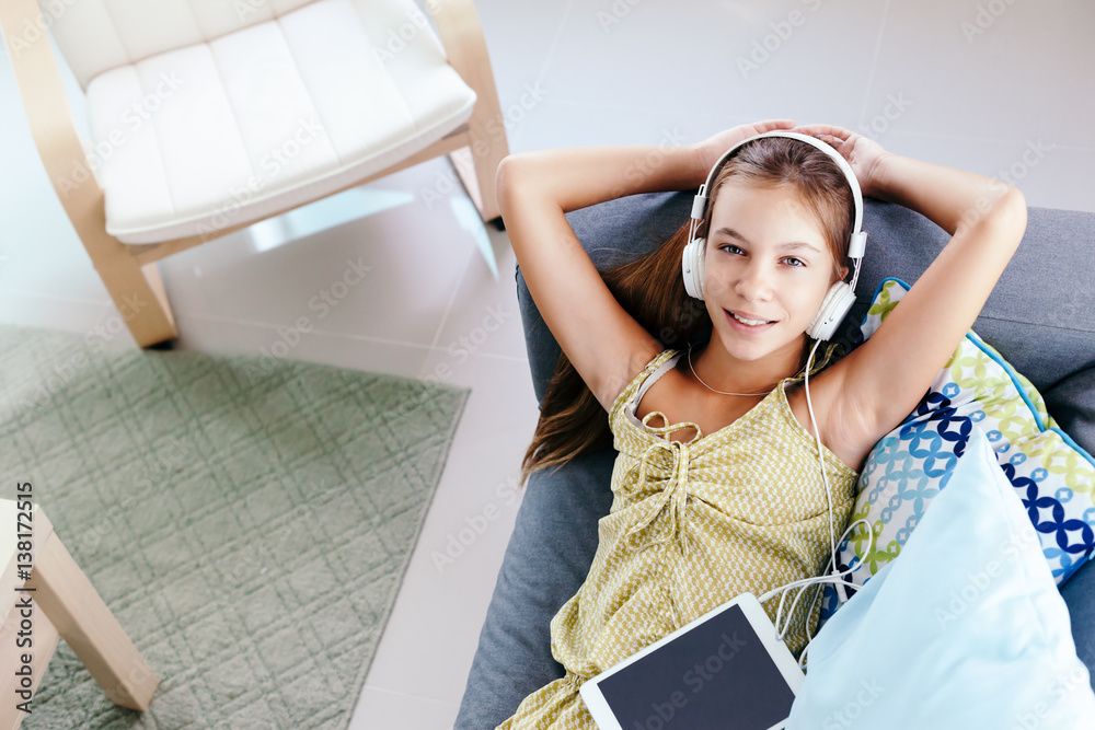 Tween girl relaxing on couch at home Stock Photo | Adobe Stock