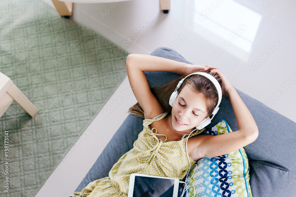 Tween girl relaxing on couch at home Stock Photo | Adobe Stock