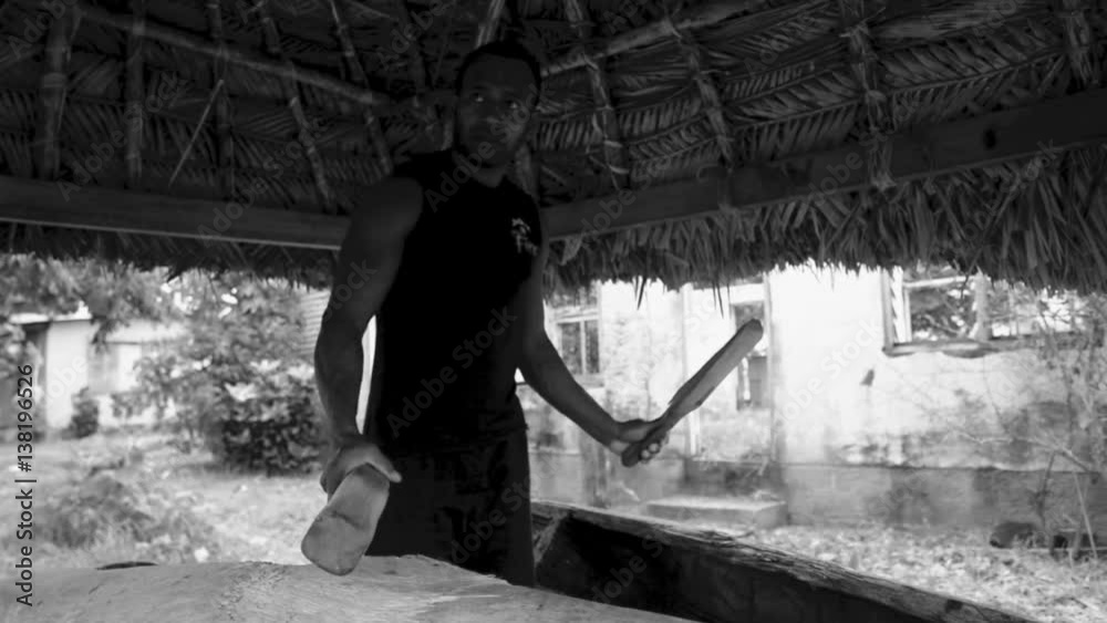 Indigenous Fijian man play on a Fijian Lali stick drum in Fiji Stock ...