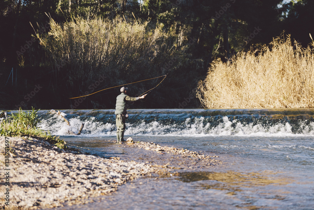 Back view of fishing person Stock Photo | Adobe Stock