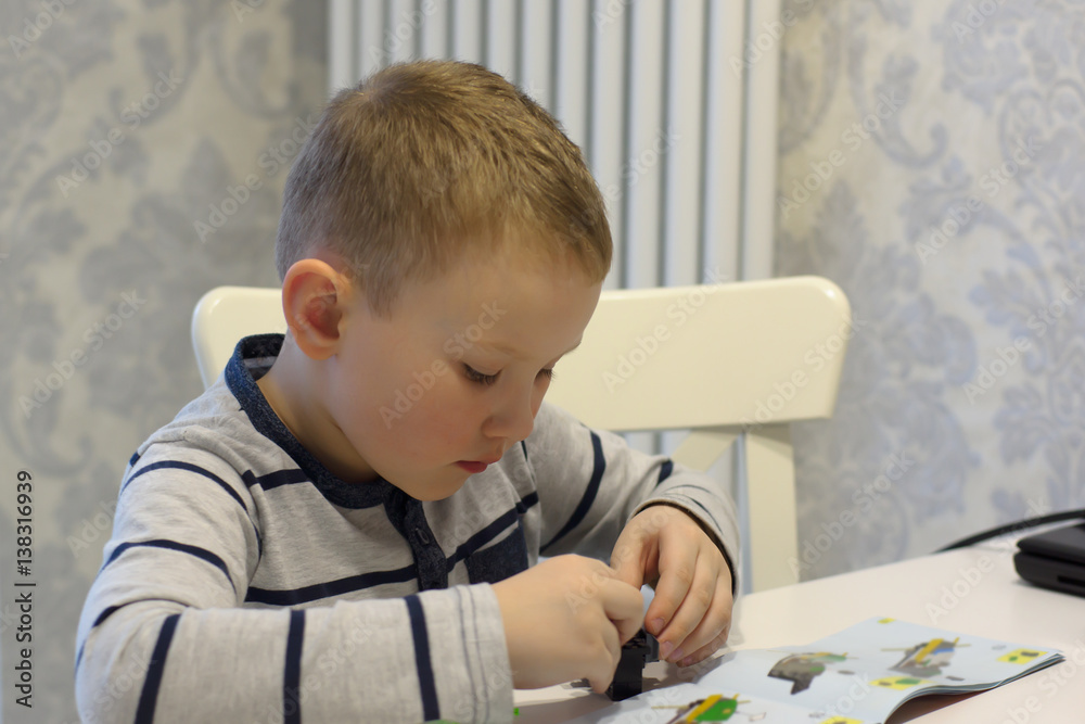 boy collects toy Stock Photo | Adobe Stock