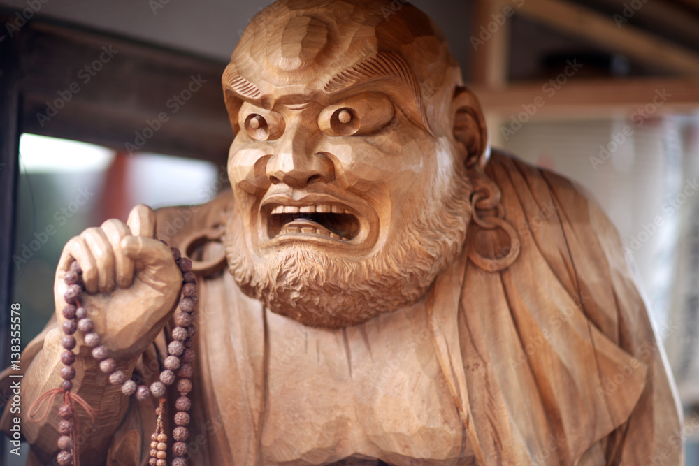 Carved wooden sculpture of the deity in the Shinto temple, Japan. Stock ...
