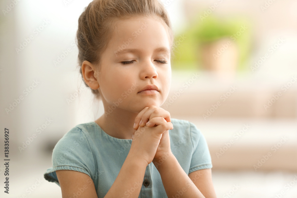 Cute little girl praying at home Stock Photo | Adobe Stock