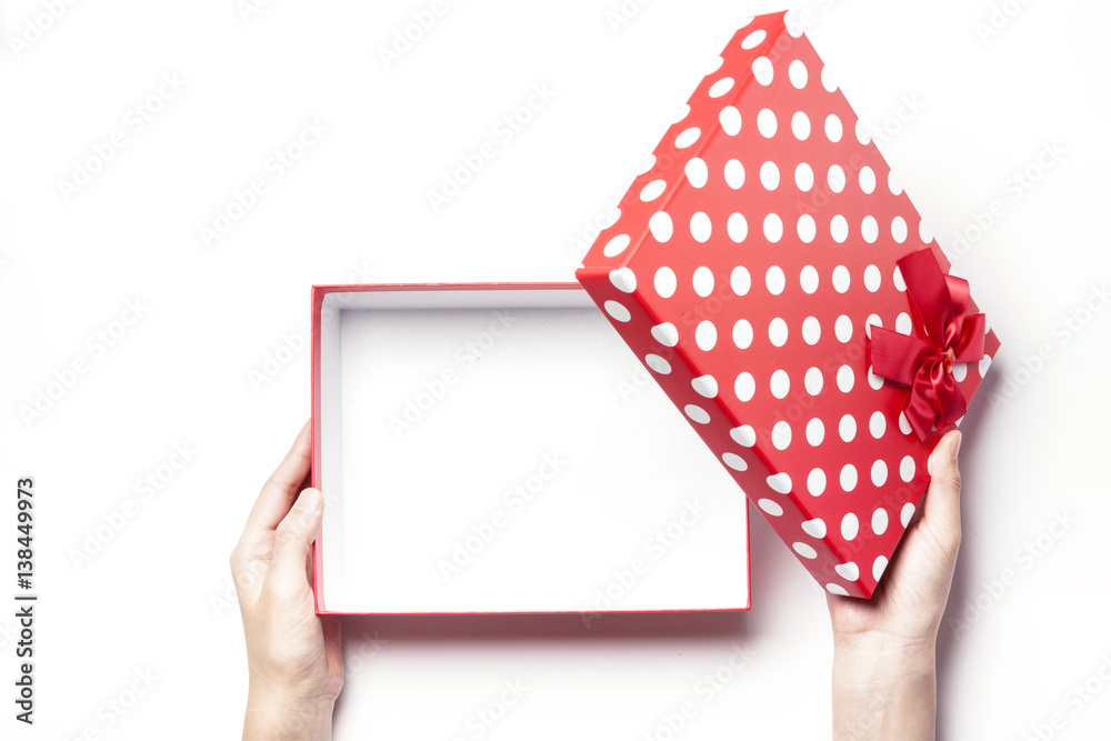 woman hand hold a empty red dot gift box with ribbon isolated white ...
