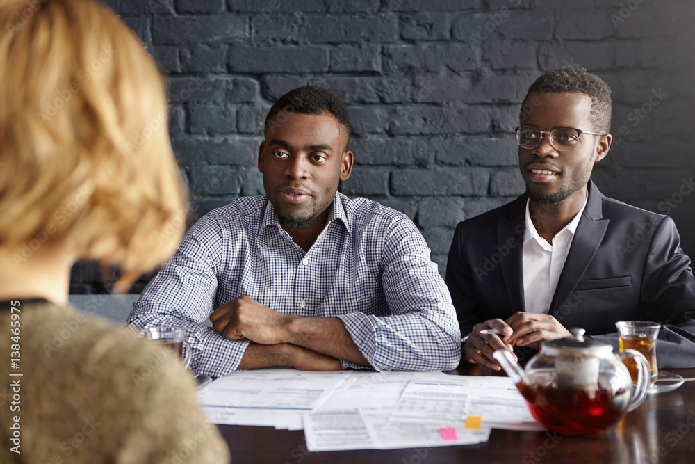 Welcome on board. Two handsome dark-skinned HR managers having ...