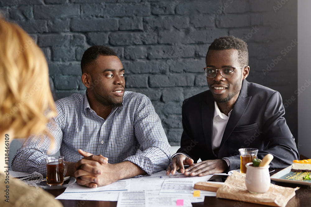 Two handsome confident African-American recruiters in formal wear ...