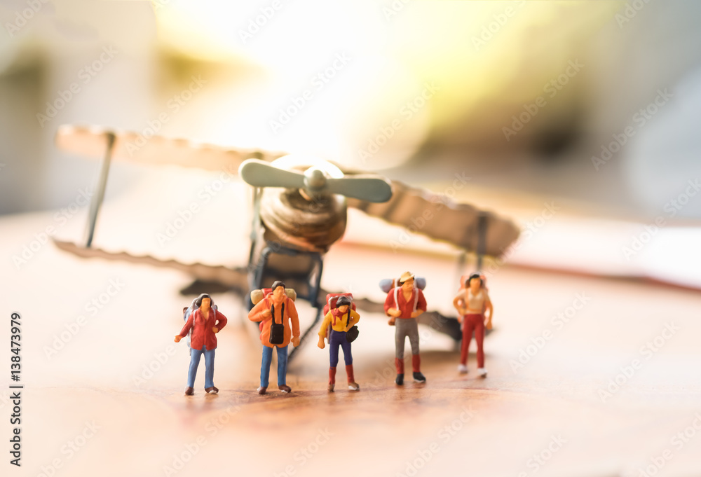 Miniature people : travellers standing on world map in front of vintage ...