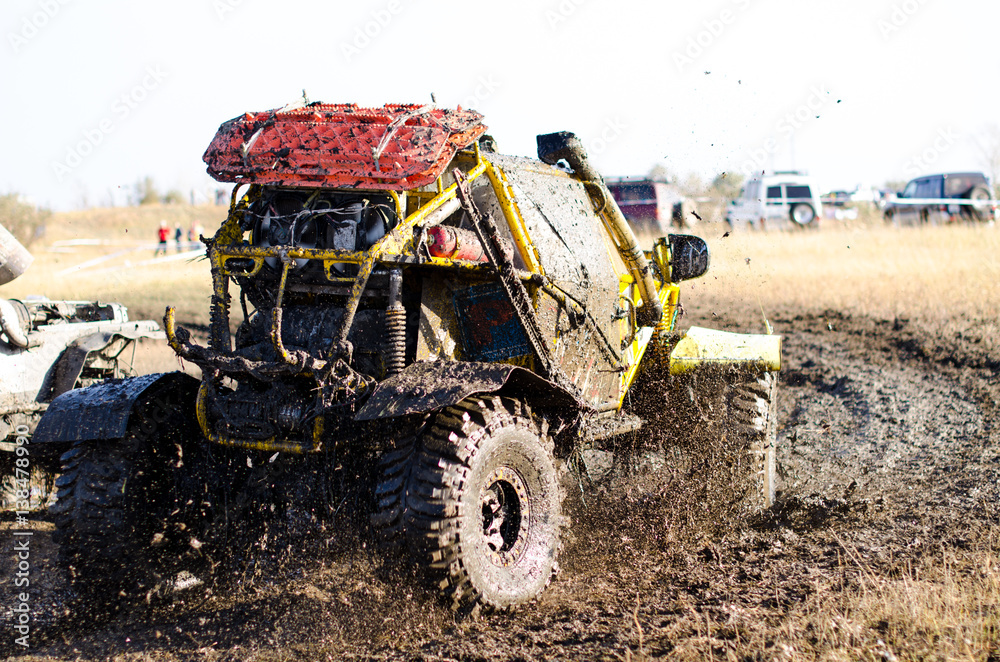 Off-road car in a puddle making mud splashes. Stock Photo | Adobe Stock