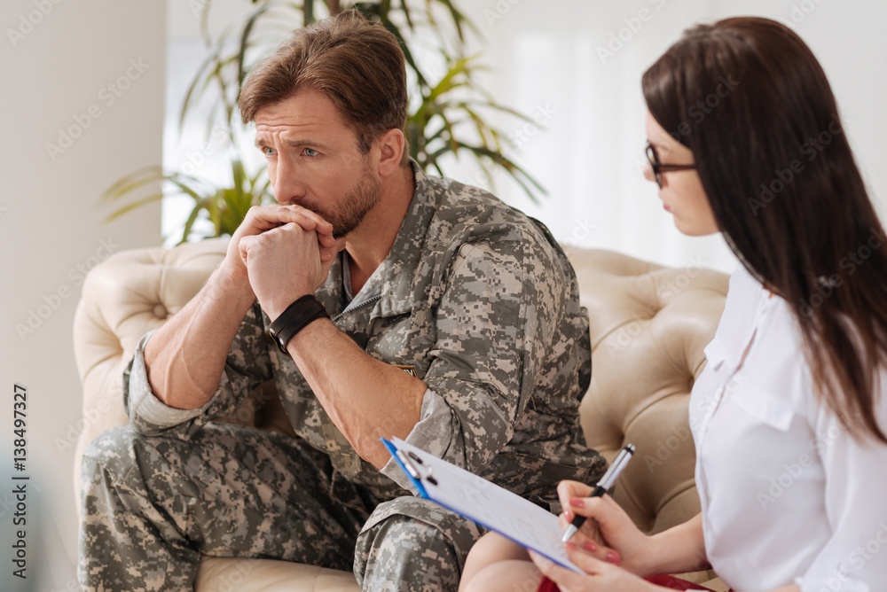 Sad depressed soldier thinking about war Stock Photo | Adobe Stock