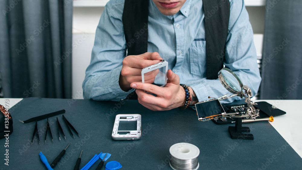 Unrecognizable man disassembling smartphone free space. Fixing process ...