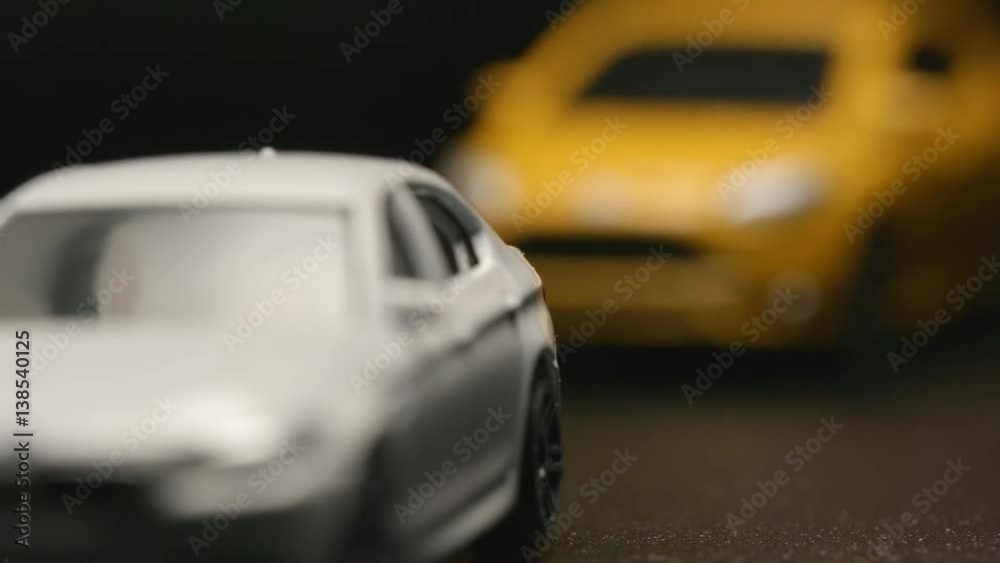 ACCIDENT: Toy model car crashes to white toy car - front view (slow ...