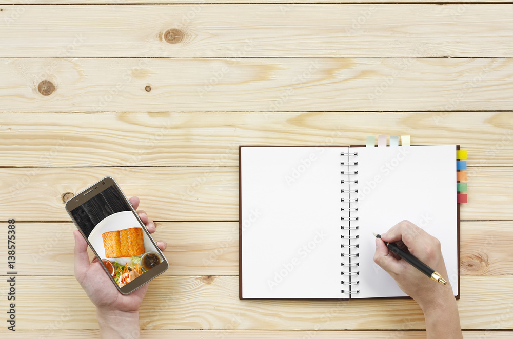 chef writing on blank recipe book or diary and menu with holding a ...