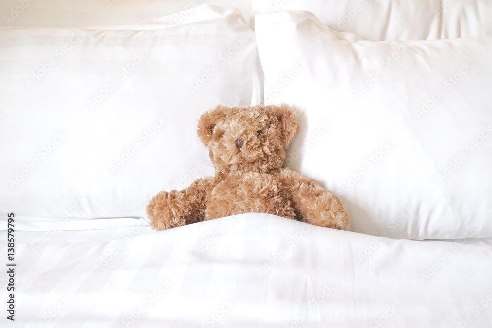 Cute teddy bear sleeping comfortably in bed, good morning and welcome a ...