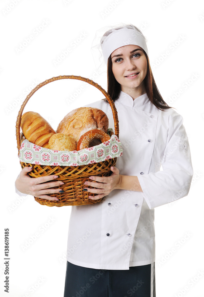 Pretty young girl baker in white uniform holding a basket with bakery ...