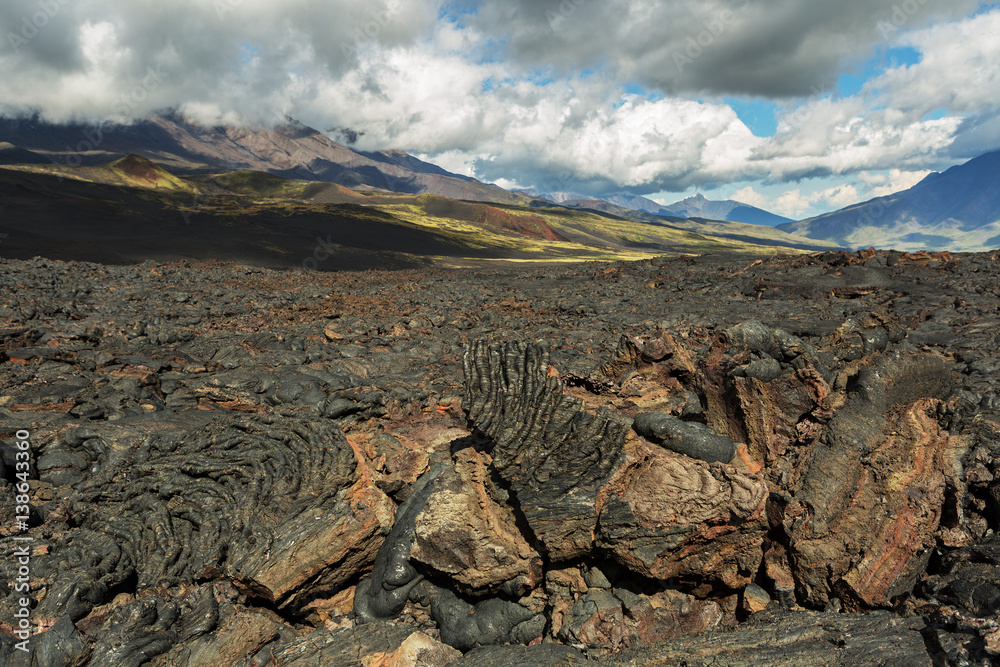 Lava field at Tolbachik volcano, after eruption in 2012 on background ...