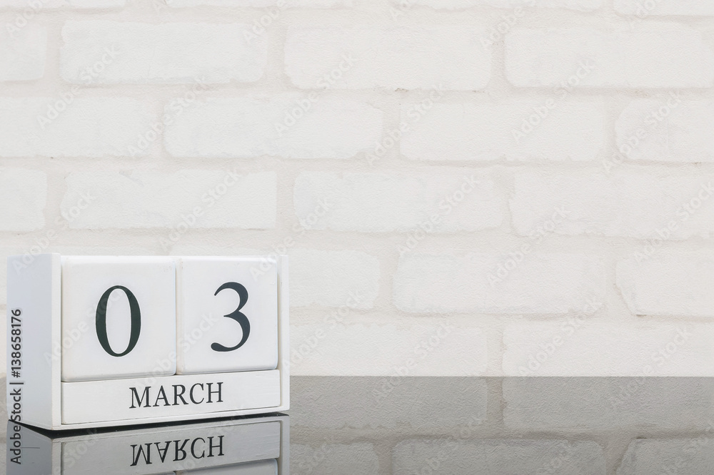 Closeup white wooden calendar with black 3 march word on black glass ...
