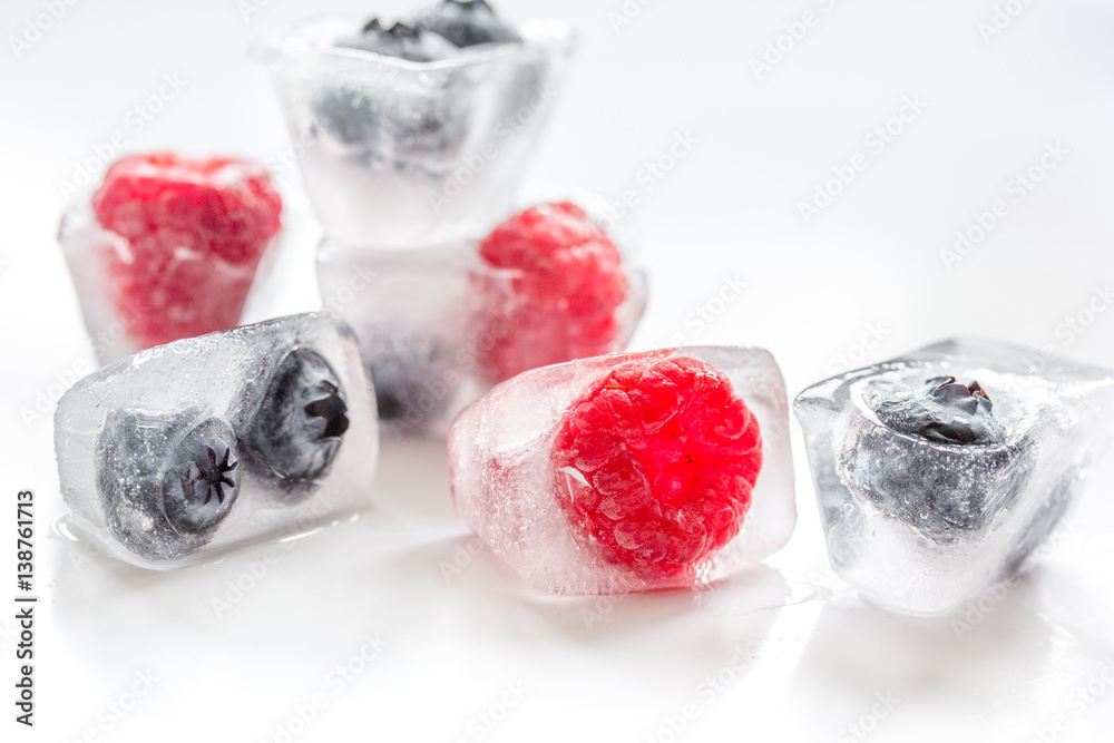 ice cubes with raspberry and blueberry on white background Stock Photo ...