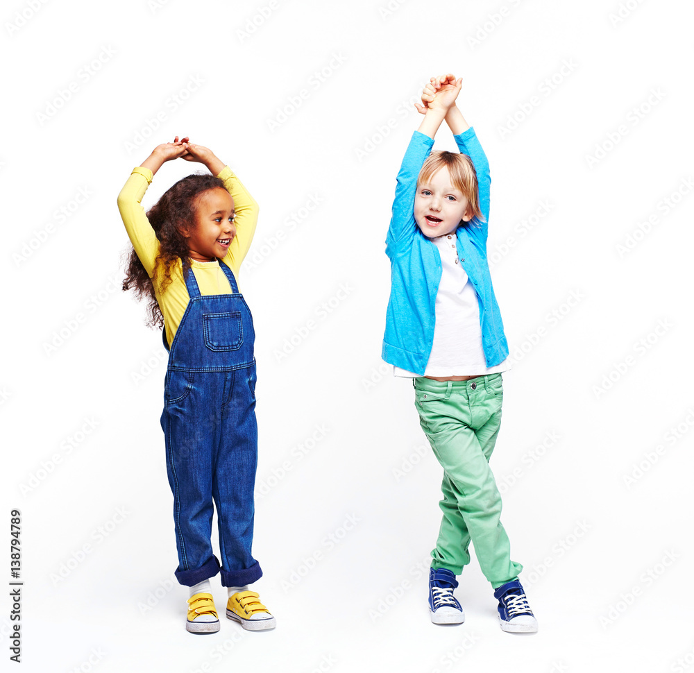 Studio portrait of children against white background: full body shot of ...