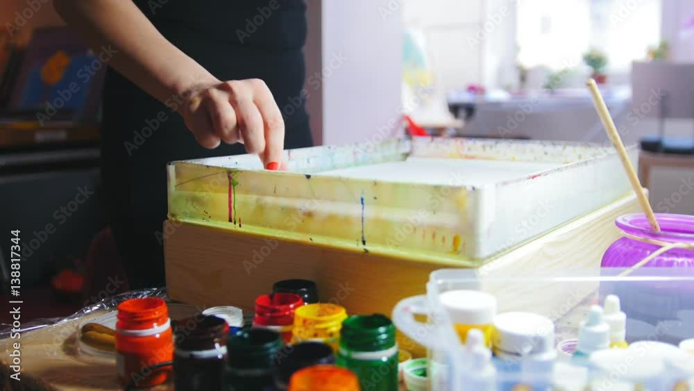Process of painting - woman draws on water in Liquid Ebru art technics ...