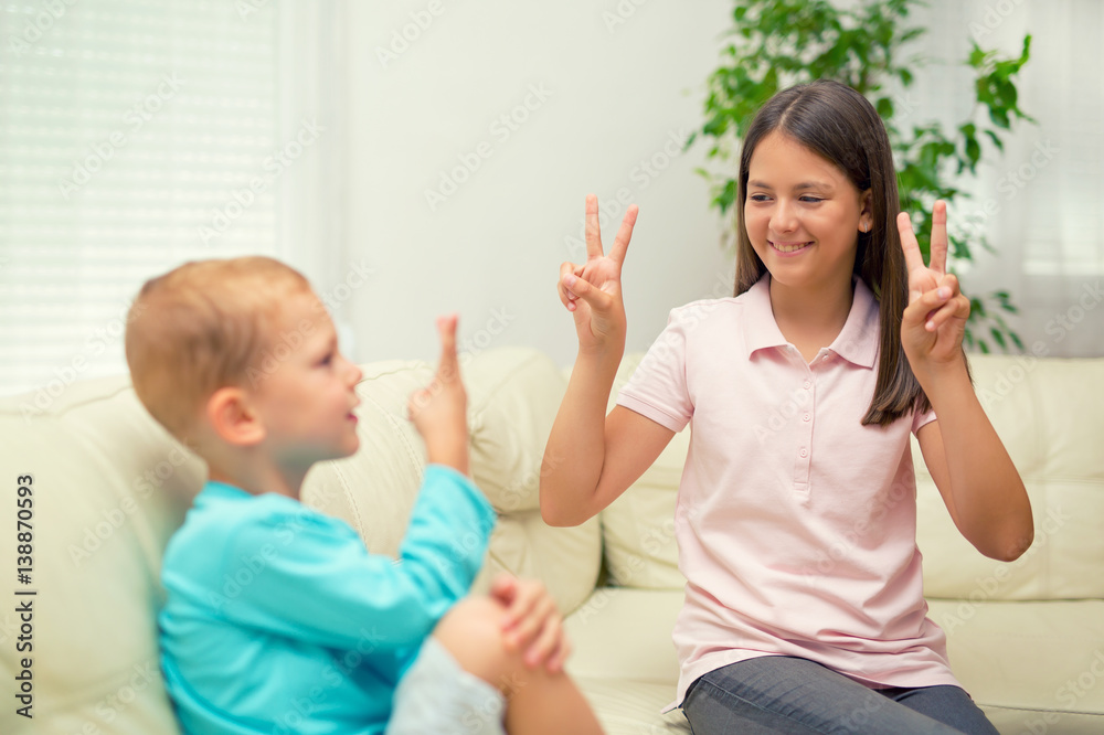 Brother and sister learn sign language at home. Deaf child Stock Photo ...