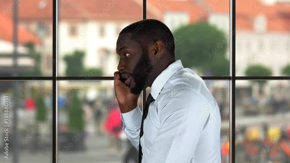 Black man talking on phone. Businessman on urban background. Leading ...
