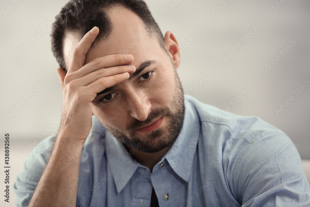 Portrait of handsome depressed man at home Stock-Foto | Adobe Stock