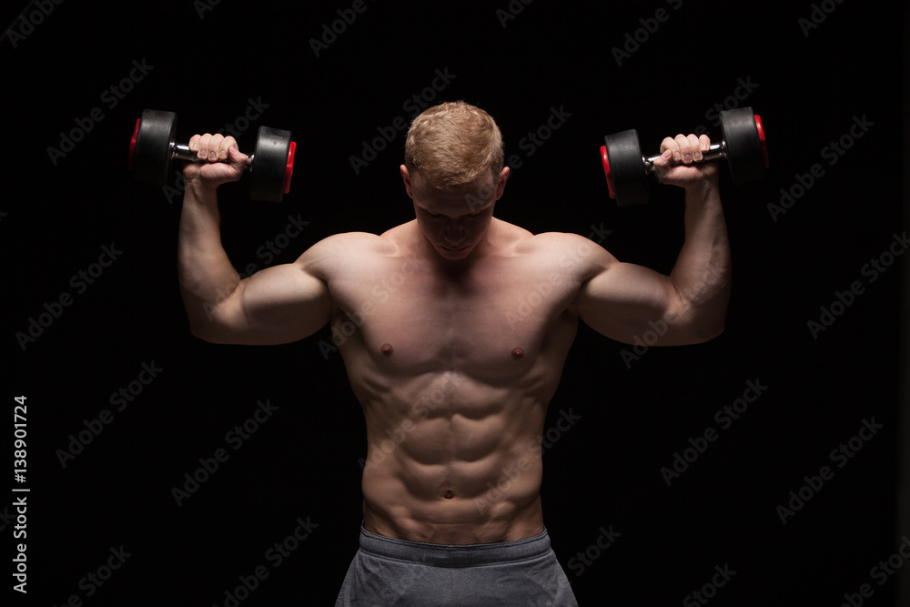 Handsome power man fitness-model with six packs is training with ...