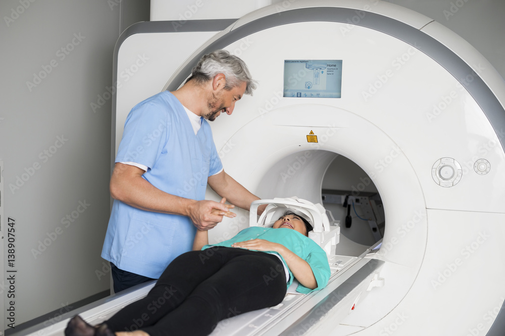 Doctor Consoling Patient Lying On CT Scan Machine Stock Photo | Adobe Stock