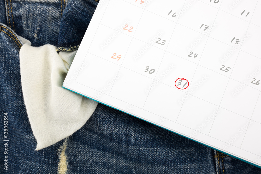 Jeans with empty pocket and calendar with a last day of the month ...