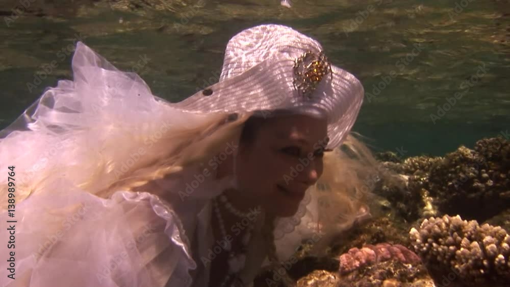 Underwater model free diver in costume pirate swims in clean water in ...