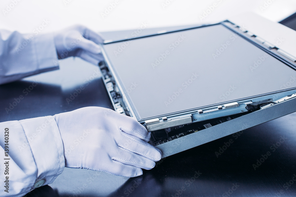 Process of computer repair. Engineer in white gloves disassembling ...
