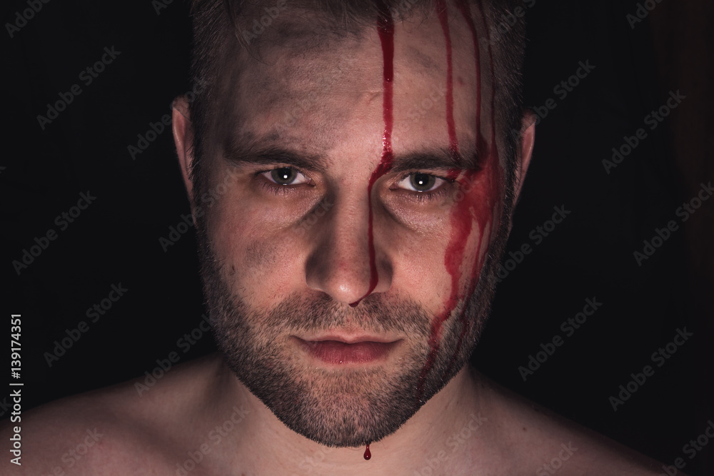 Portrait of man with blood on his face on dark background. Stock Photo ...