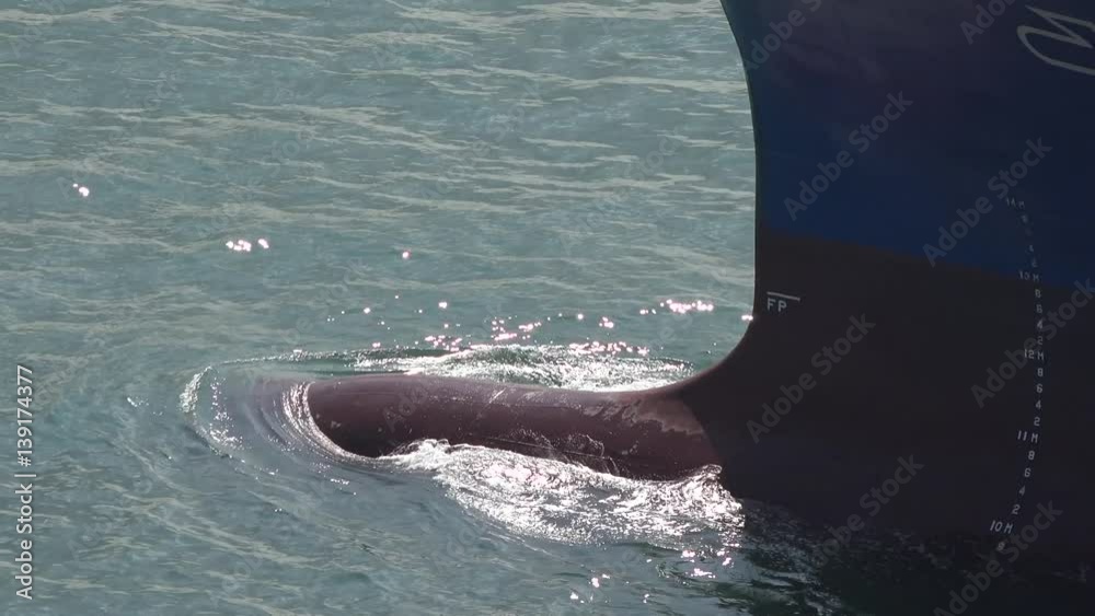 A bulbous bow of a cargo ship in the ocean. The bulb modifies the way ...