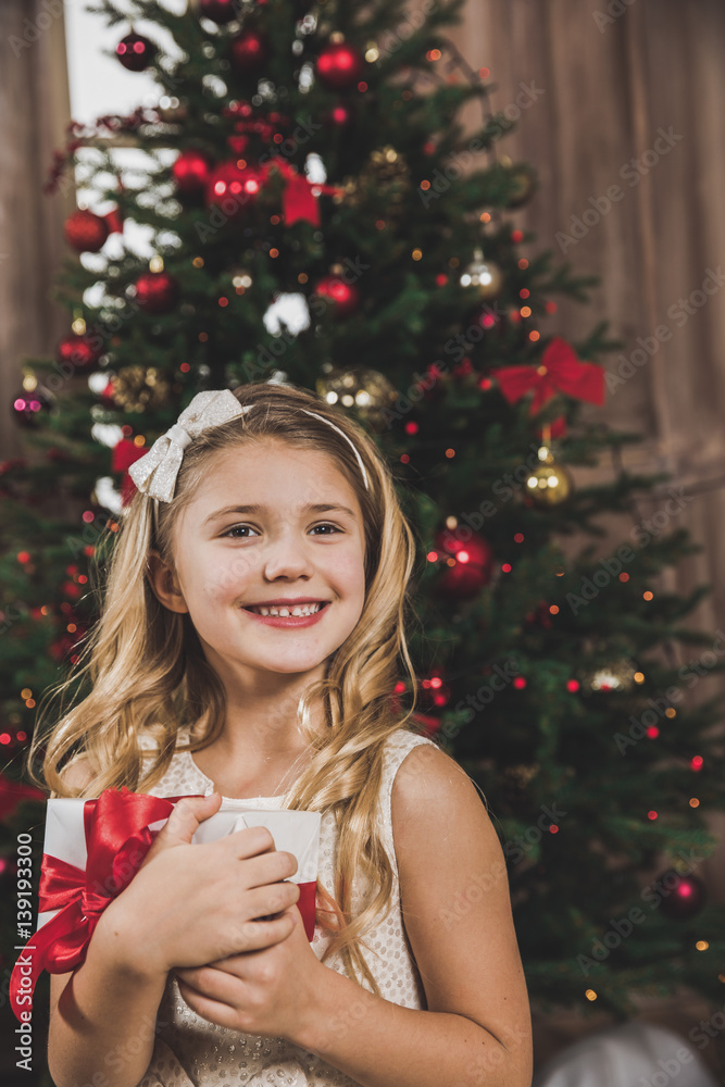 Girl holding gift box Stock Photo | Adobe Stock