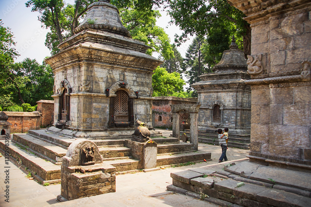 Children among votive temples and shrines at Hindu Pashupatinath Temple ...