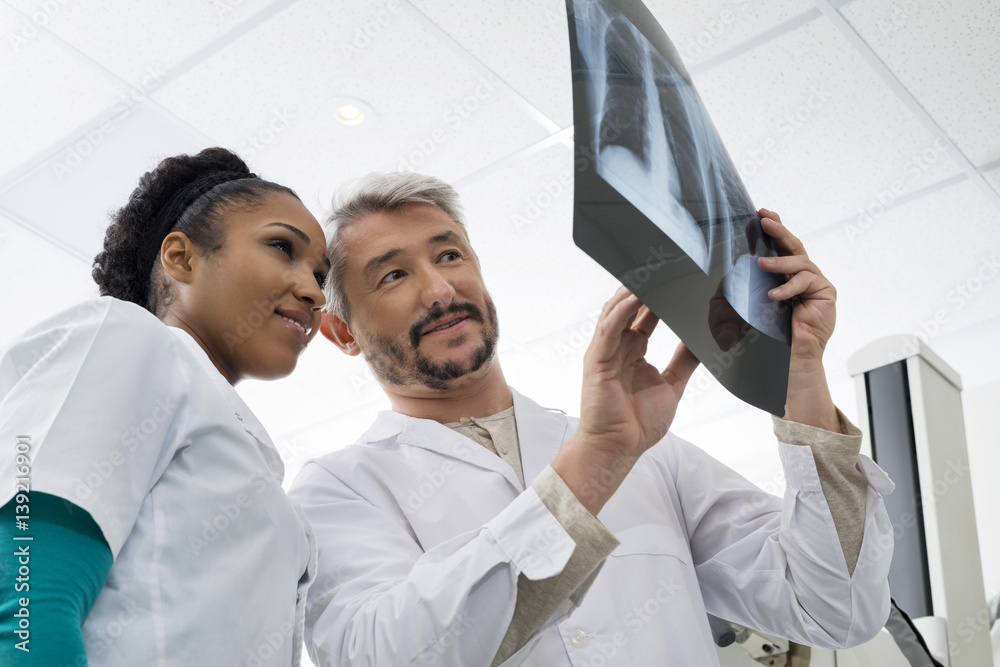 Radiologists Analyzing Chest X-ray In Examination Room Stock Photo ...