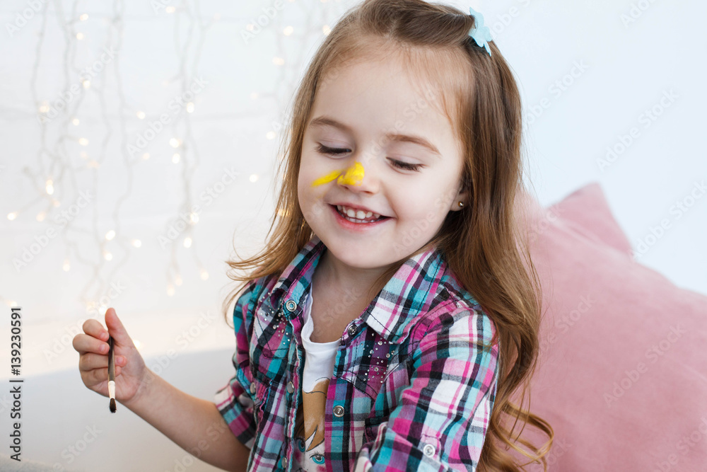 Charming girl with dark blonde hair and noses painted in yellow Stock ...
