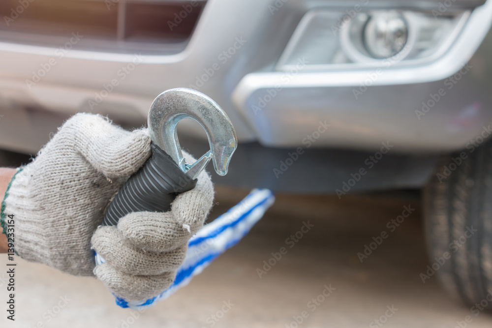 Hand holding tow rope near towing hook assembled to a broken car Stock ...