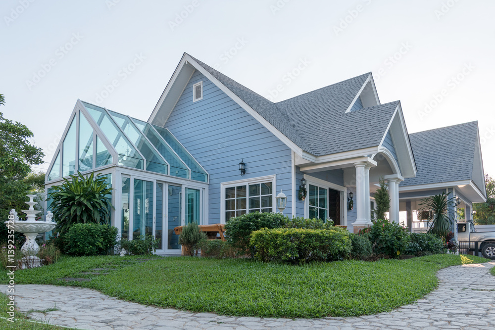 Bright blue house in sunlght with colorful poppies and some graceful ...
