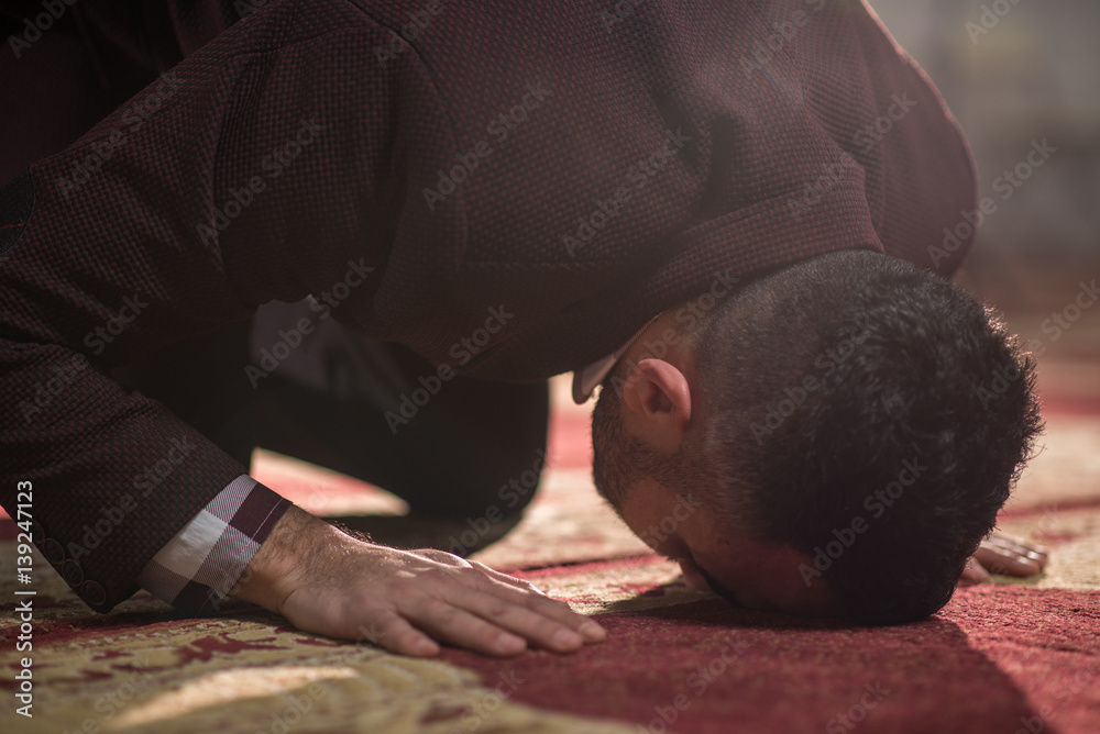 Muslim prostrating on the ground Stock Photo | Adobe Stock