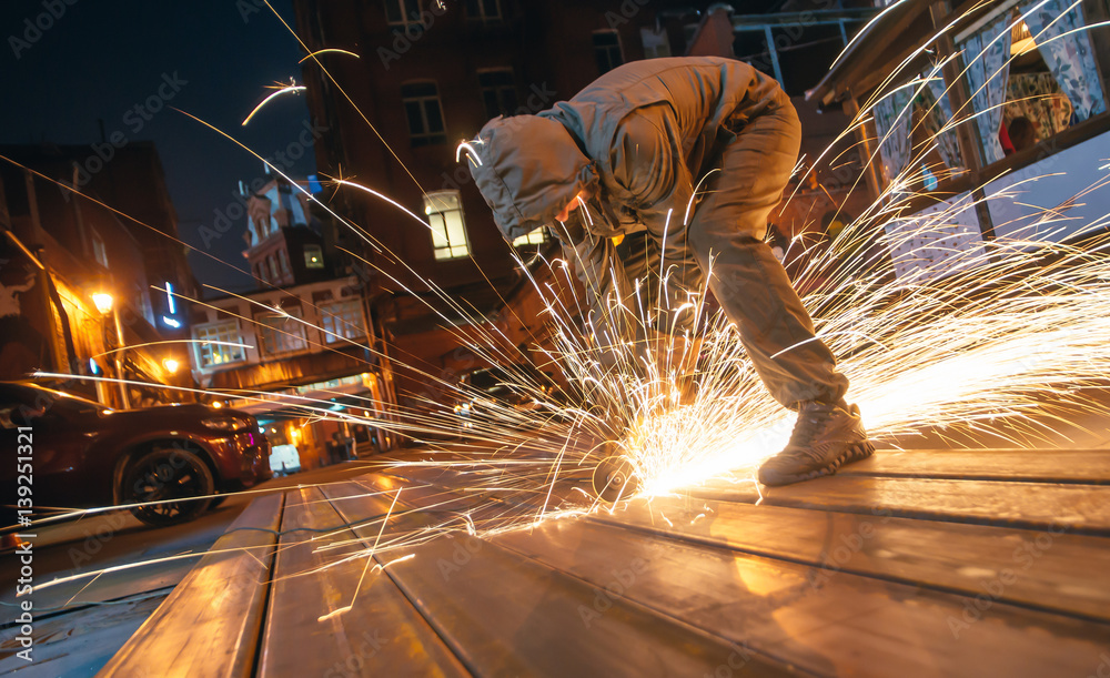 Professional worker cuts metal by electric saw. Fountain of sparks ...