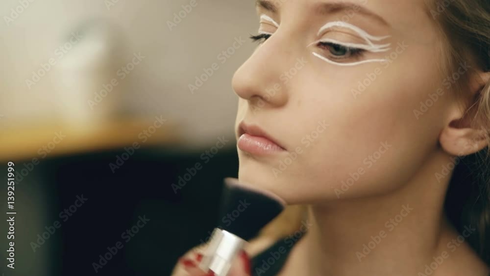 Make-up artist makes young actress girl beautiful makeup for face ...