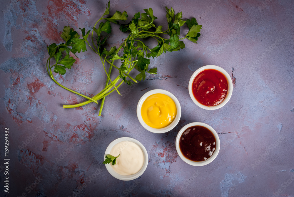 Classic set of sauces in white saucers: American yellow mustard ...