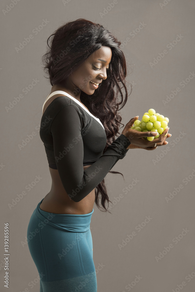 Beautiful African American black fitness model holding a bunch of ...