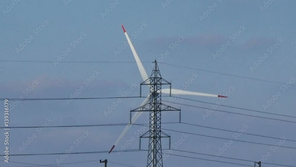 Slow motion zoomout from close up shot of white wind turbine with red ...