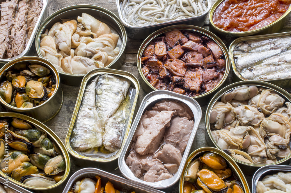 Assortment of cans of canned with different types of fish and seafood ...