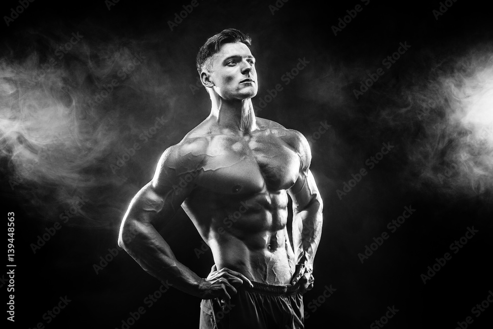 Strong bodybuilder man with perfect body- abs, shoulders, biceps ...