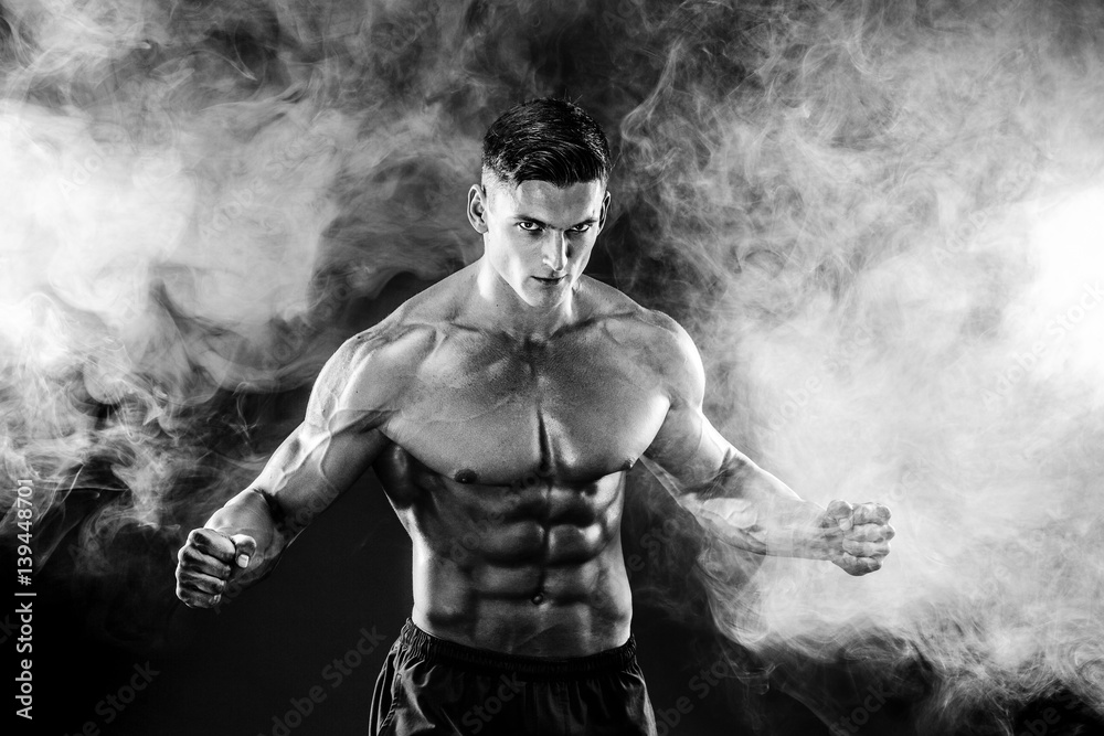 Strong bodybuilder man with perfect body- abs, shoulders, biceps ...